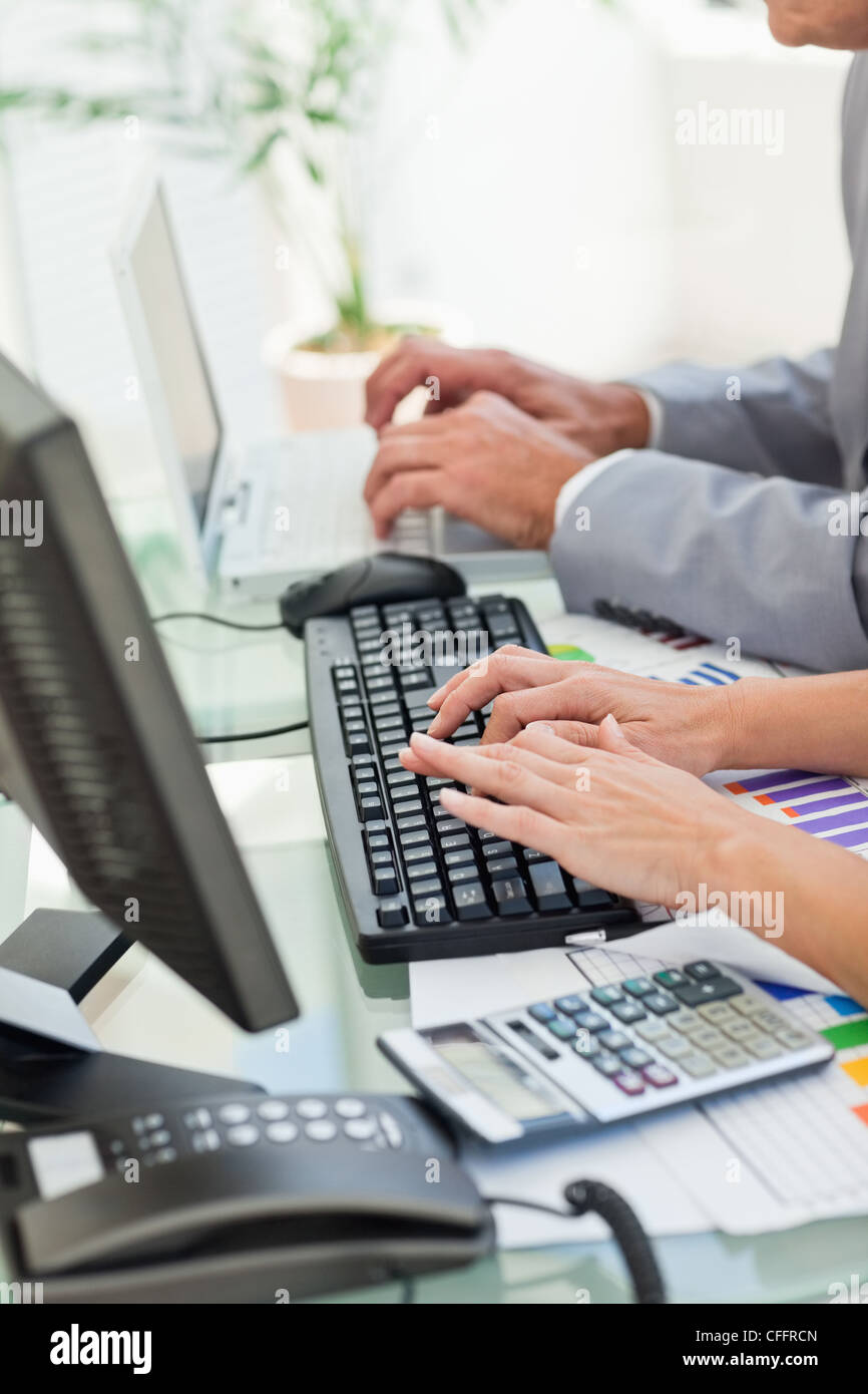 Business people working together on computers Stock Photo - Alamy