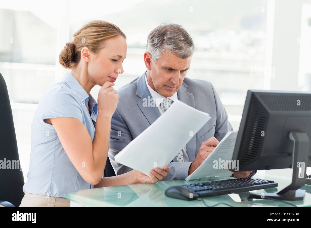 Boss showing files to his employee Stock Photo - Alamy