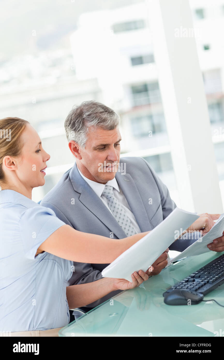 Employee giving files to her boss Stock Photo - Alamy