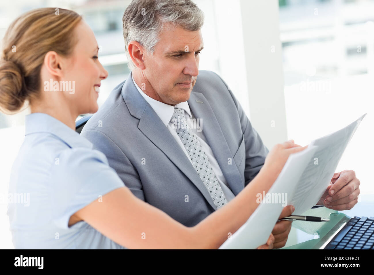 Boss working on files to his employee Stock Photo - Alamy