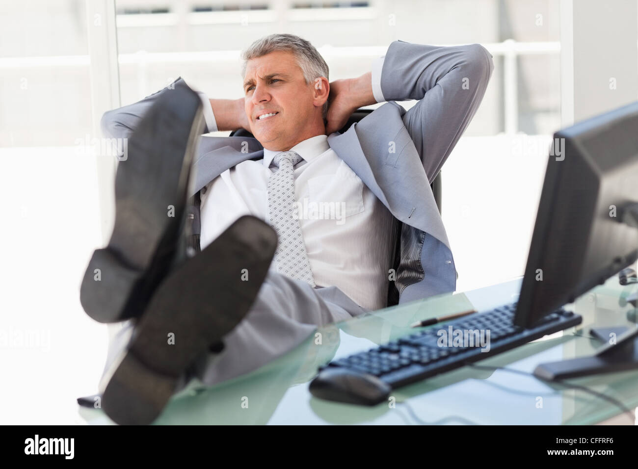 Boss smiling feet on desk hi-res stock photography and images - Alamy