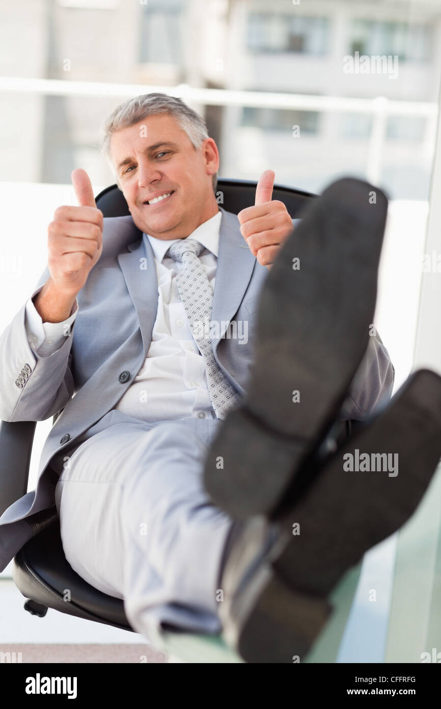 Boss smiling feet on desk hi-res stock photography and images - Alamy