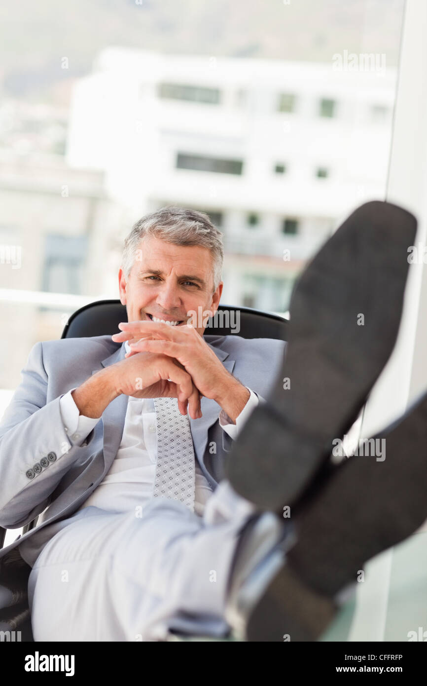 Boss smiling feet on desk hi-res stock photography and images - Alamy