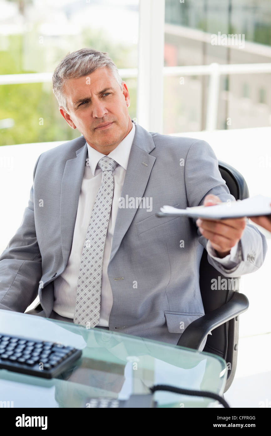 Businessman giving files Stock Photo - Alamy