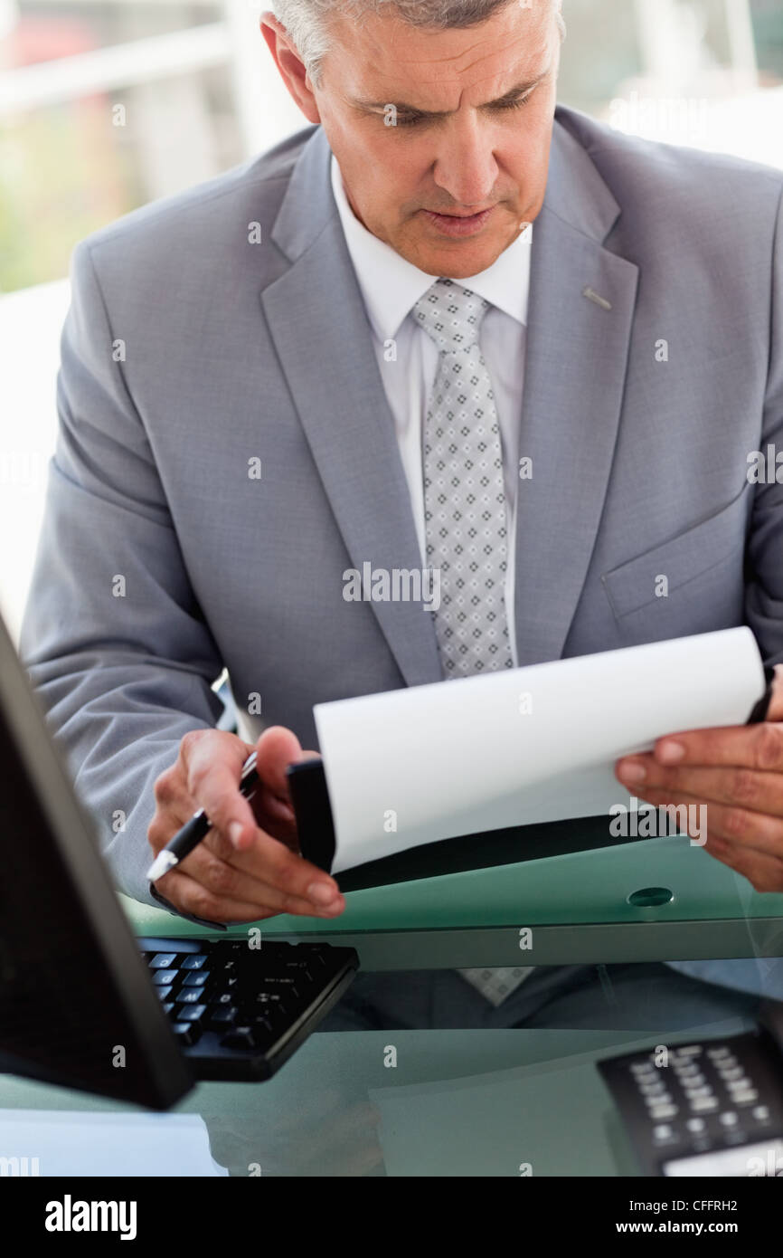 Boss signing files Stock Photo - Alamy