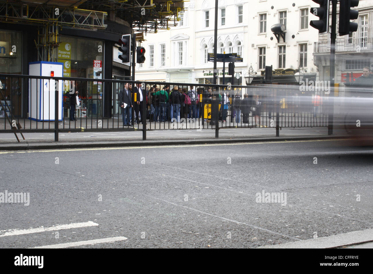 vehicles and people at a pedestrian crossing. Lancaster Place, London ...