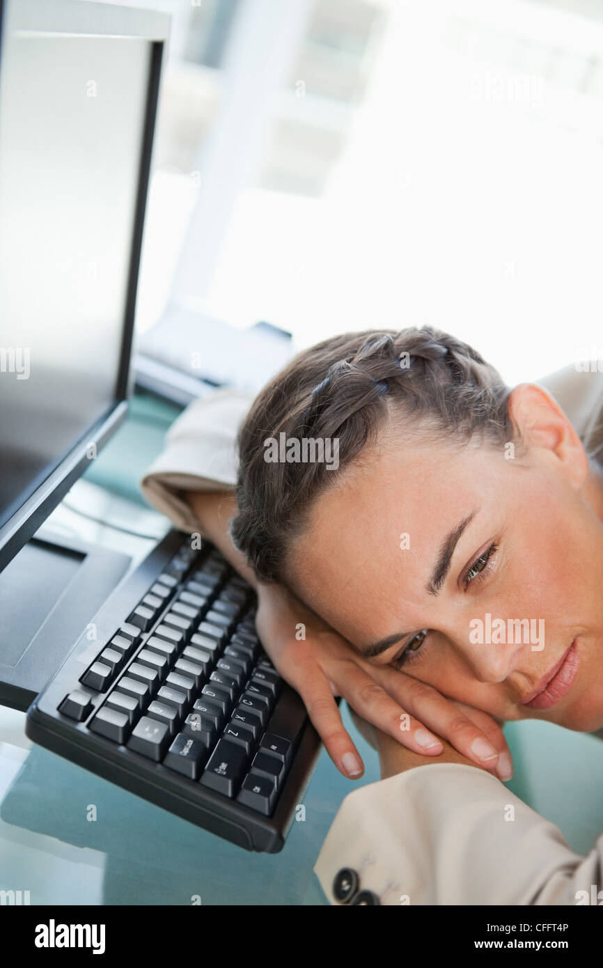 Female with braid head on the keyboard Stock Photo - Alamy