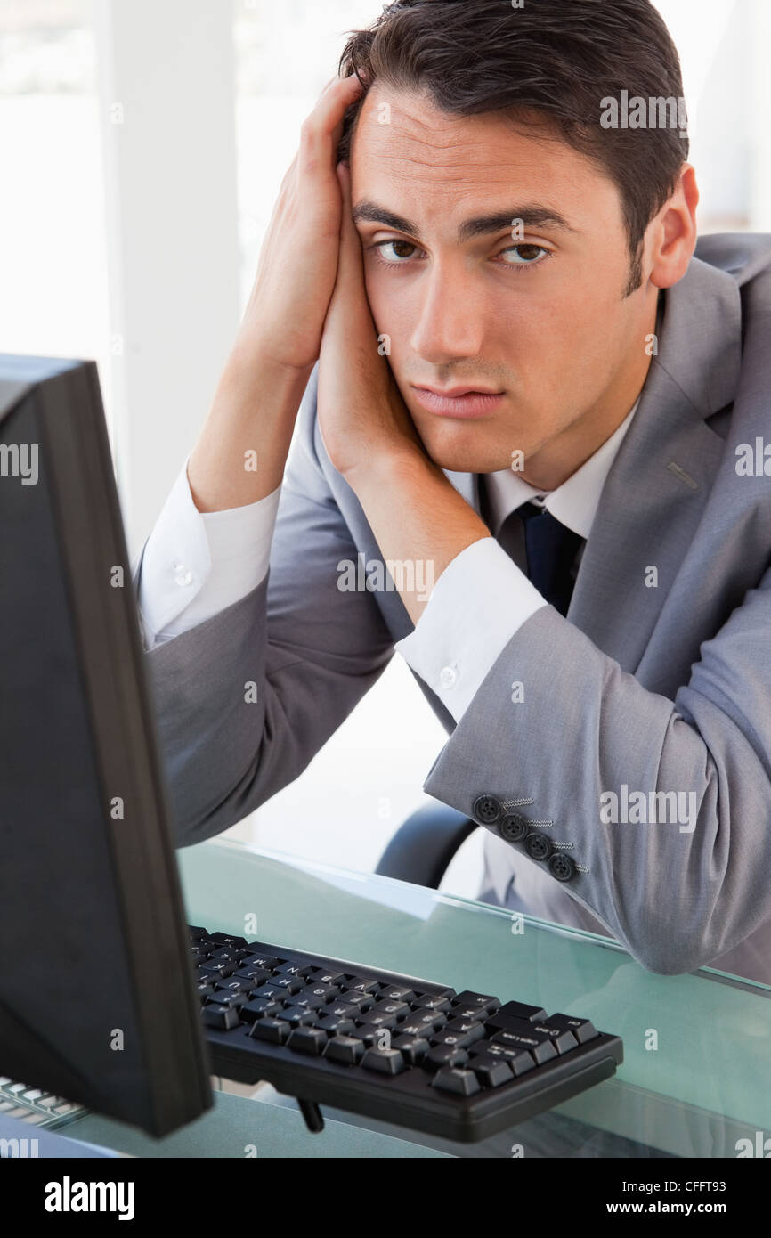 Portrait of a tired businessman in front of his computer Stock Photo ...
