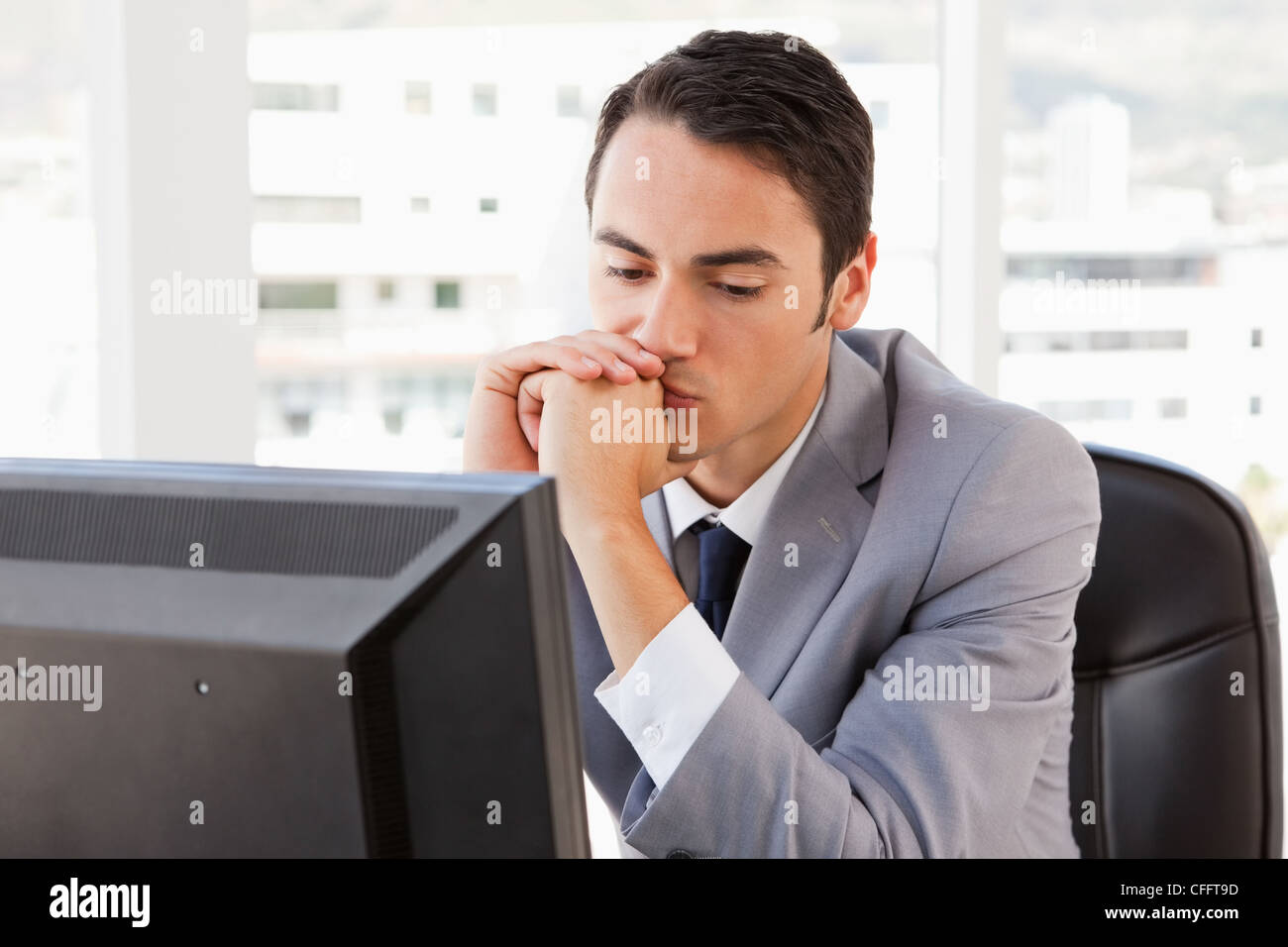 Bored businessman in front of his computer Stock Photo - Alamy