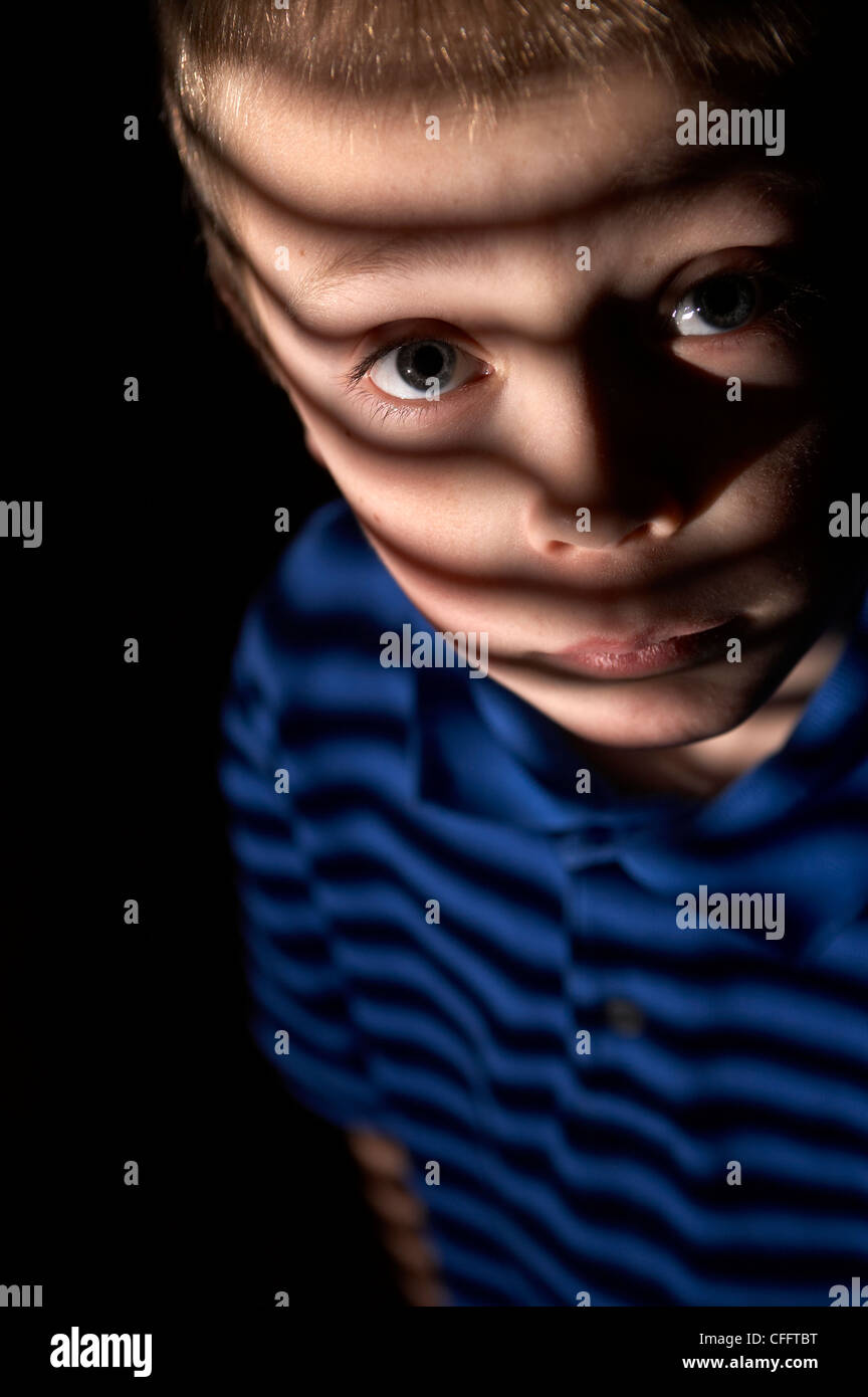 Boy in Light from Window Blinds Stock Photo - Alamy