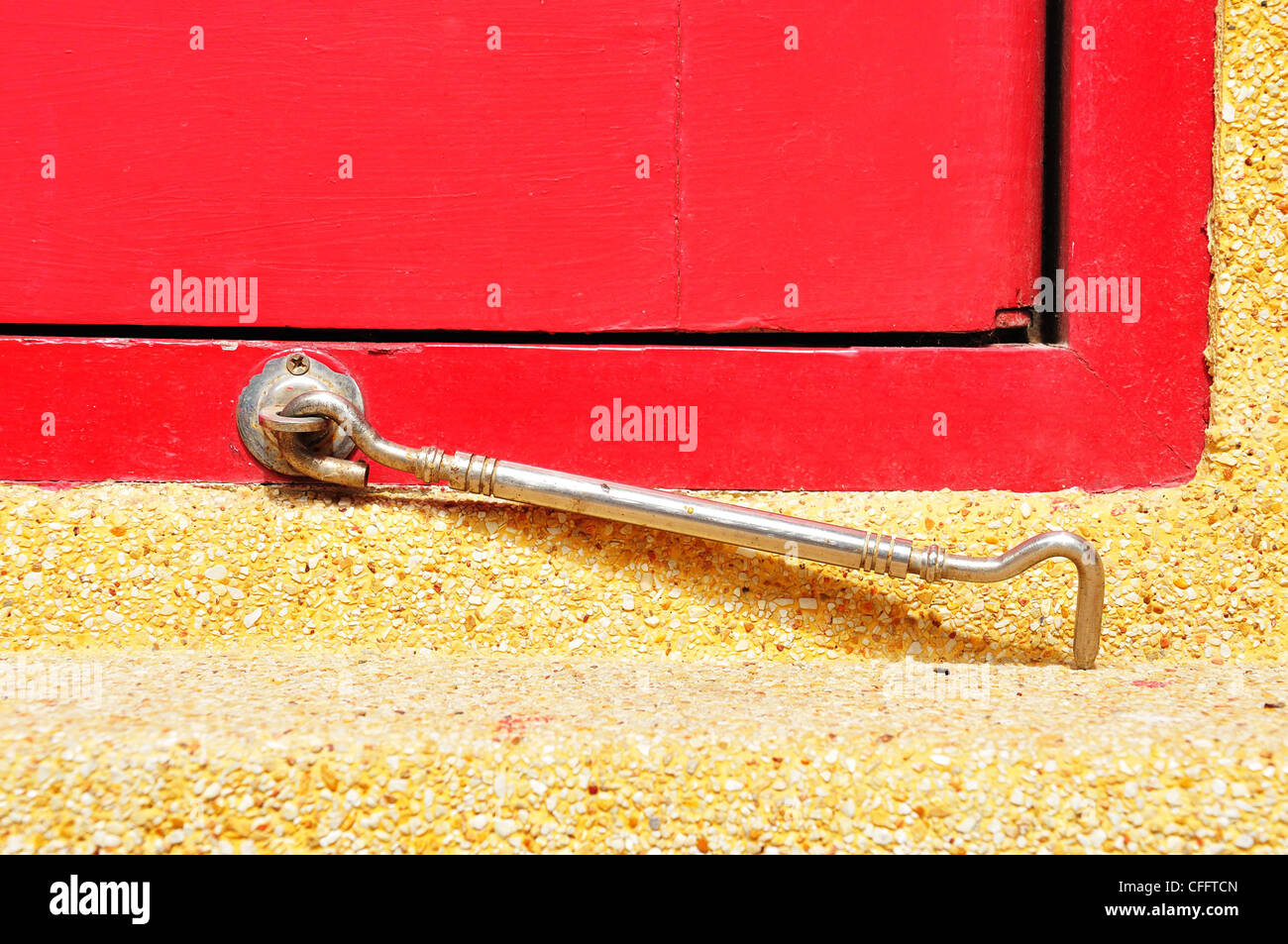 Pair of window hook on red wood window Stock Photo - Alamy