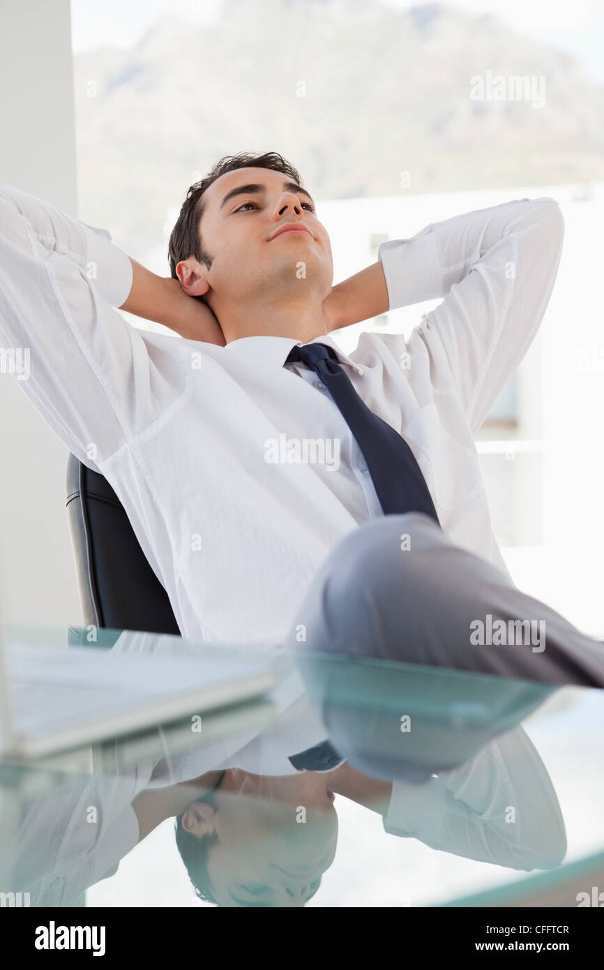 Businessman at ease at work Stock Photo - Alamy