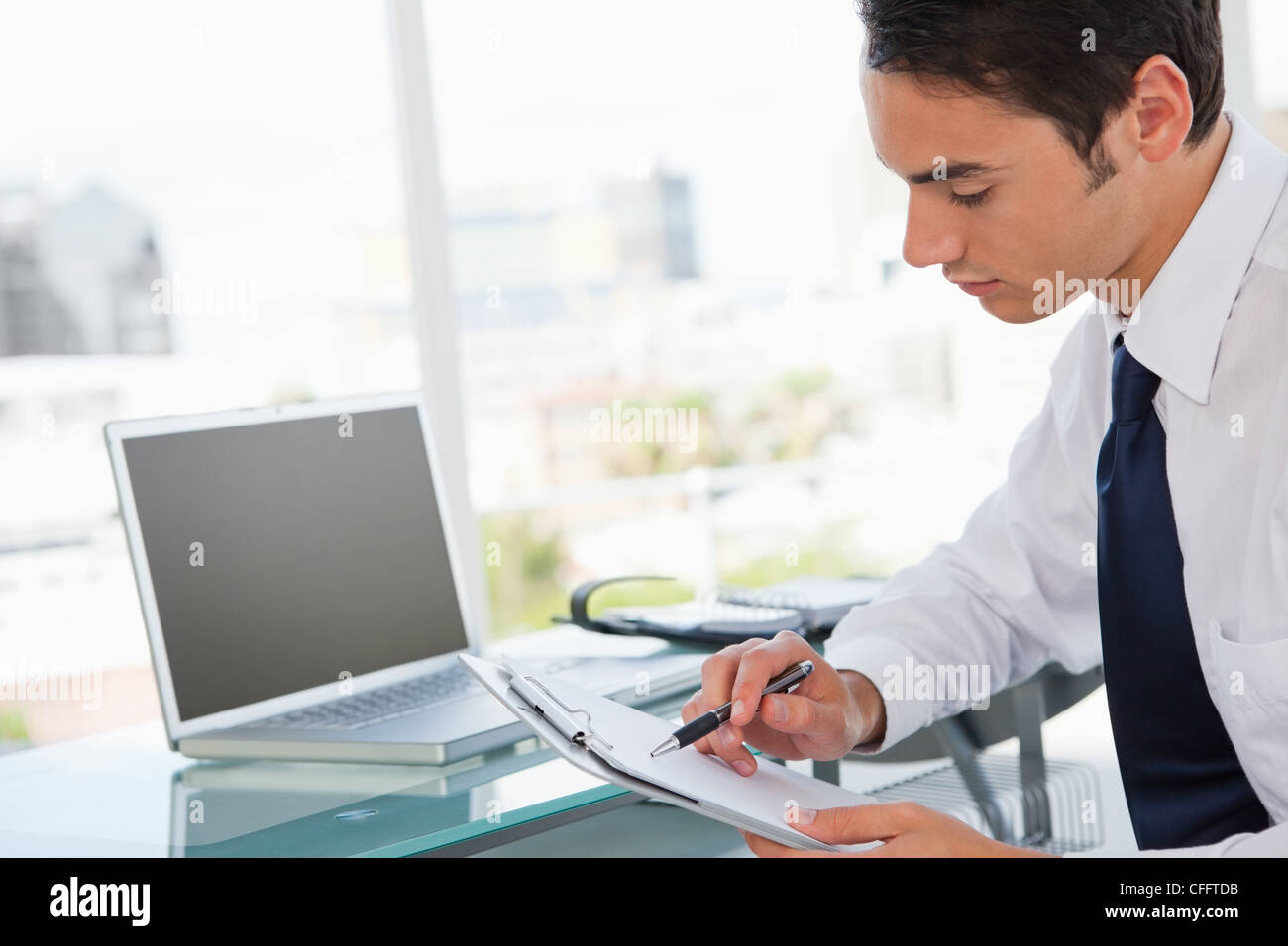 Businessman reading a file Stock Photo - Alamy