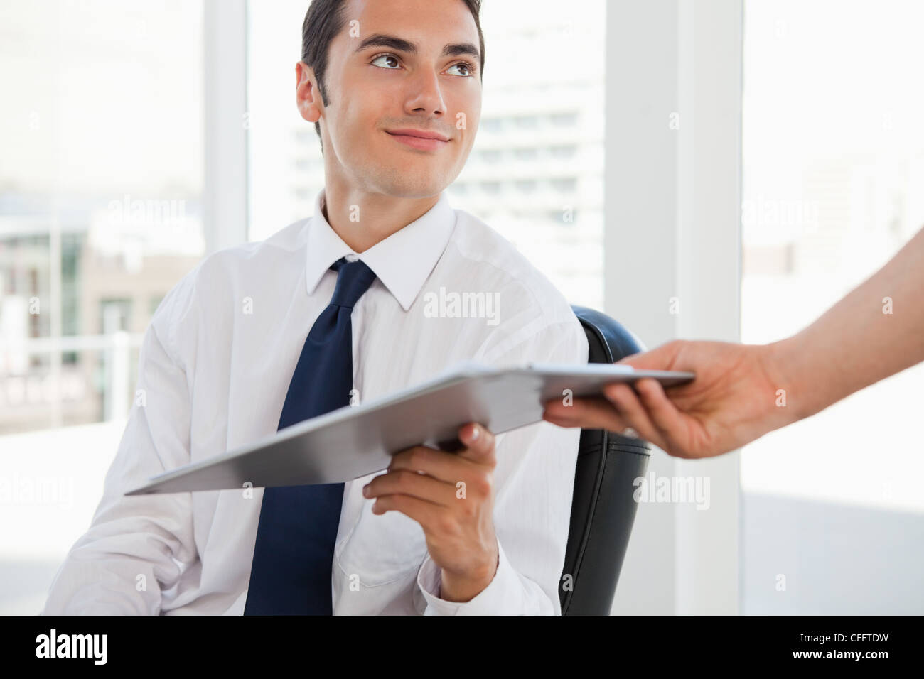 Businessman giving a file Stock Photo - Alamy
