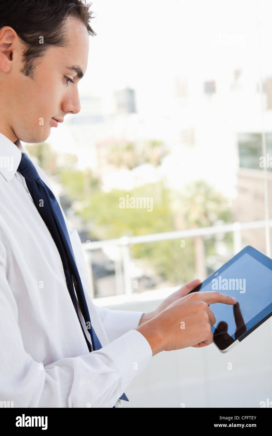 Businessman using a touch pad while standind Stock Photo - Alamy