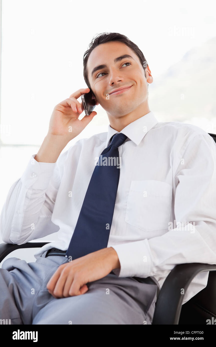 Smiling businessman calling with his smartphone Stock Photo - Alamy