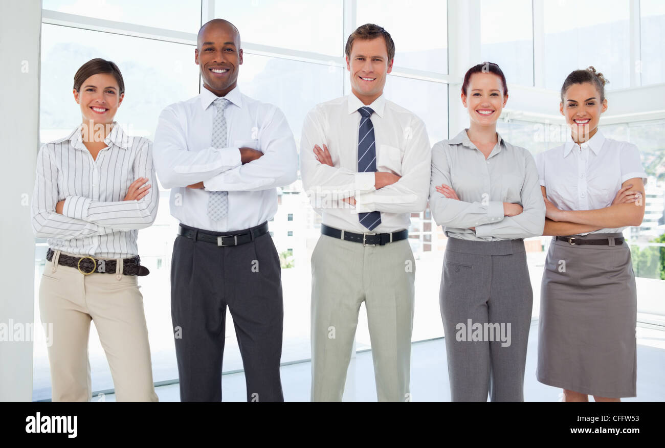 Smiling Business team with arms folded Stock Photo - Alamy