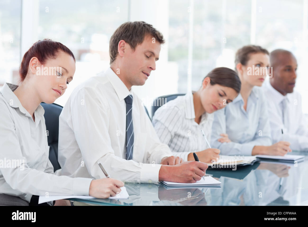 Business team taking down notes in the office Stock Photo - Alamy
