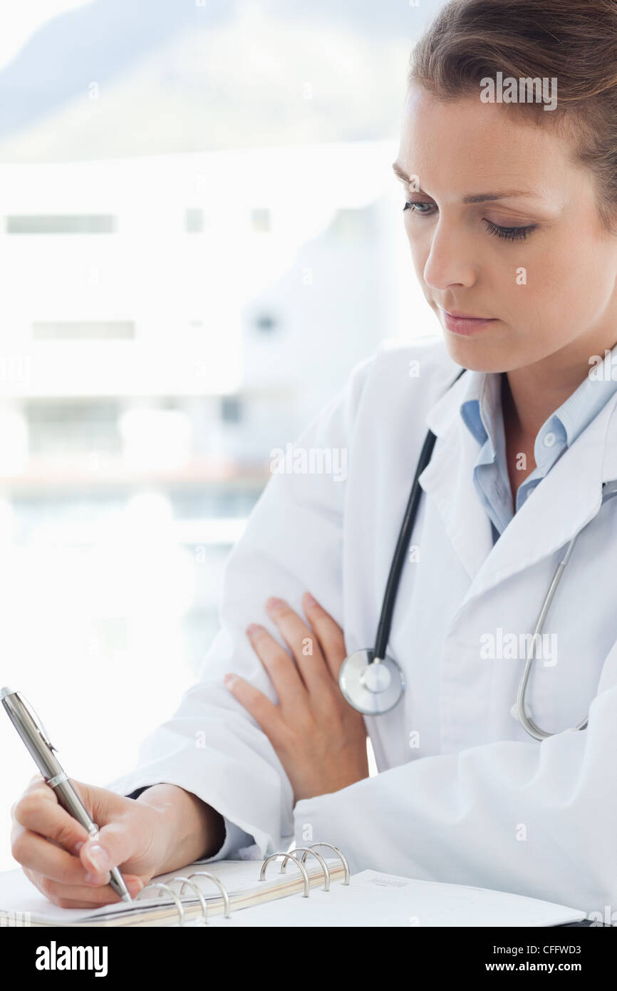 Doctor taking notes Stock Photo - Alamy