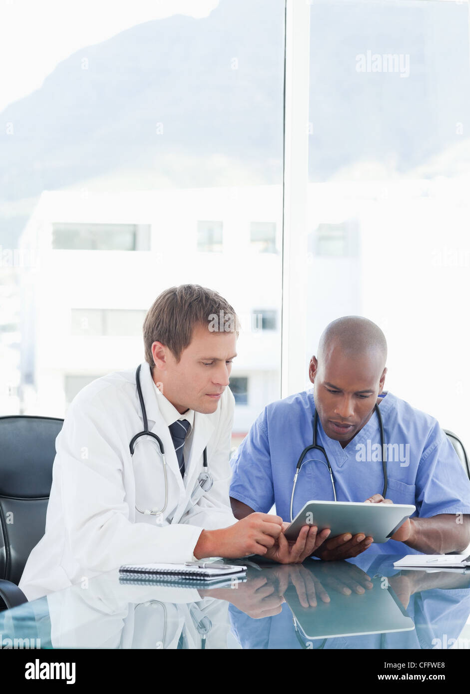 Doctors using tablet computer Stock Photo - Alamy
