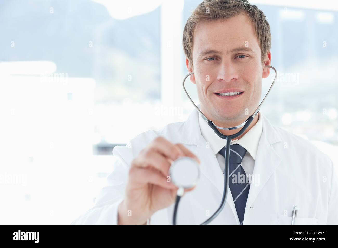 Doctor using stethoscope Stock Photo - Alamy