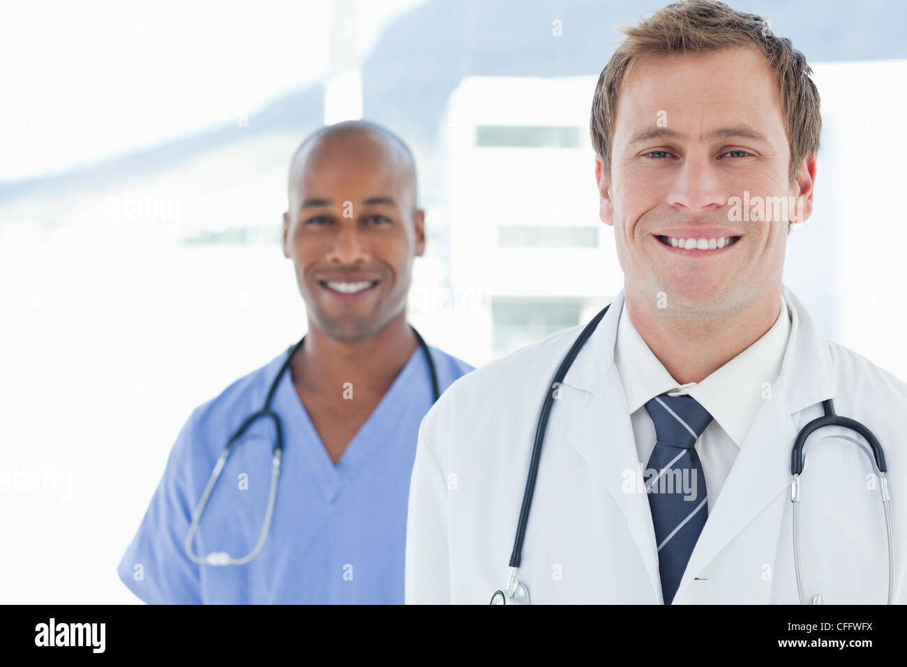 Smiling doctors standing in line Stock Photo - Alamy