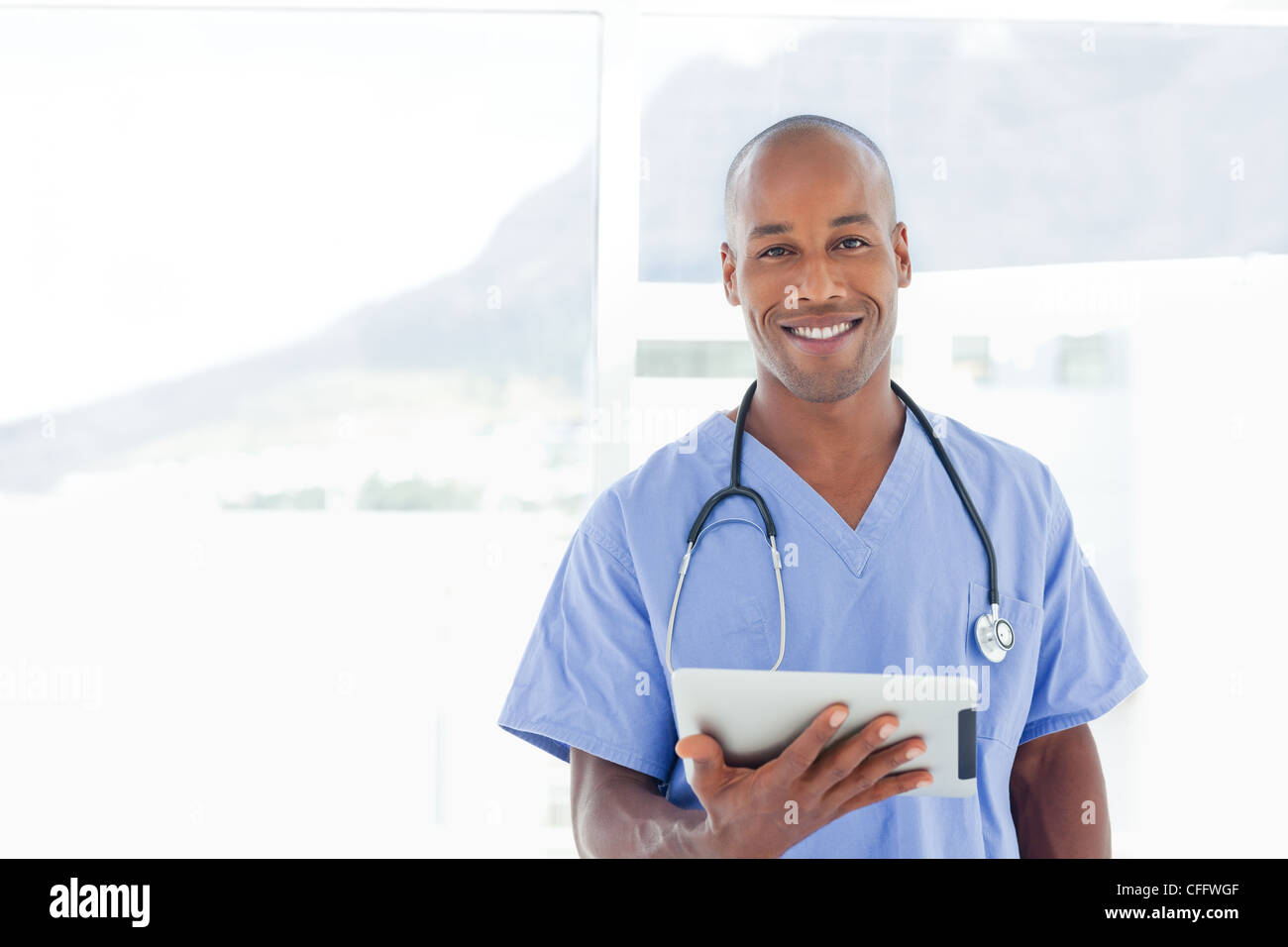 Smiling doctor with tablet computer Stock Photo - Alamy