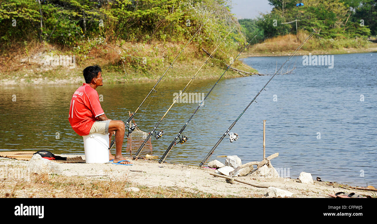 Man sitting alone fishing in lake. Thailand Stock Photo - Alamy