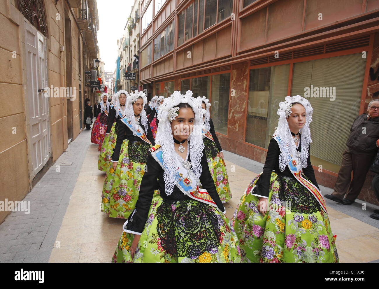 Spanish girls wearing traditional clothing during the street procession ...