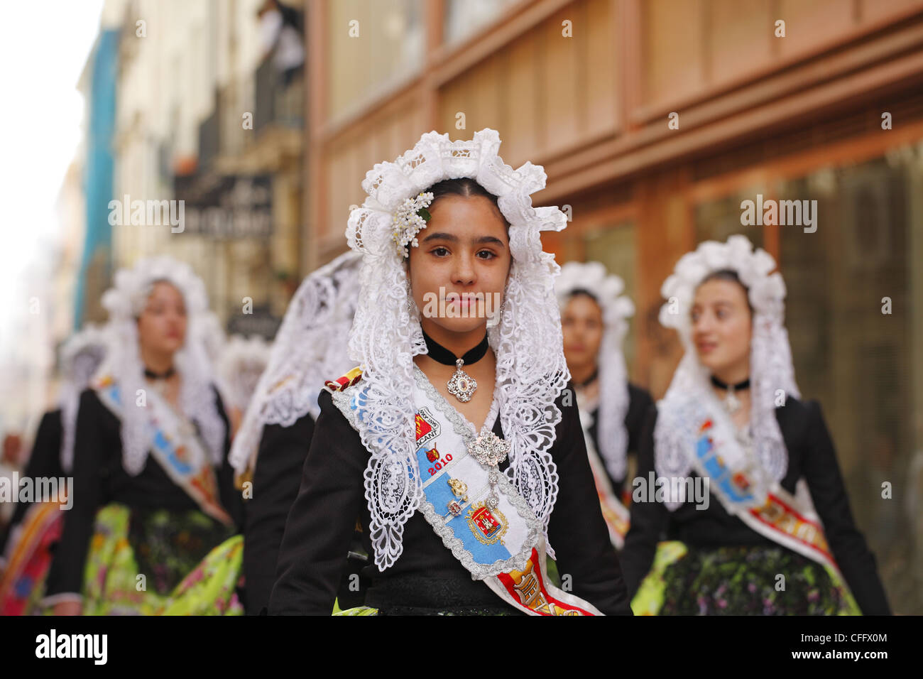 Spanish girls wearing traditional clothing during the street procession ...