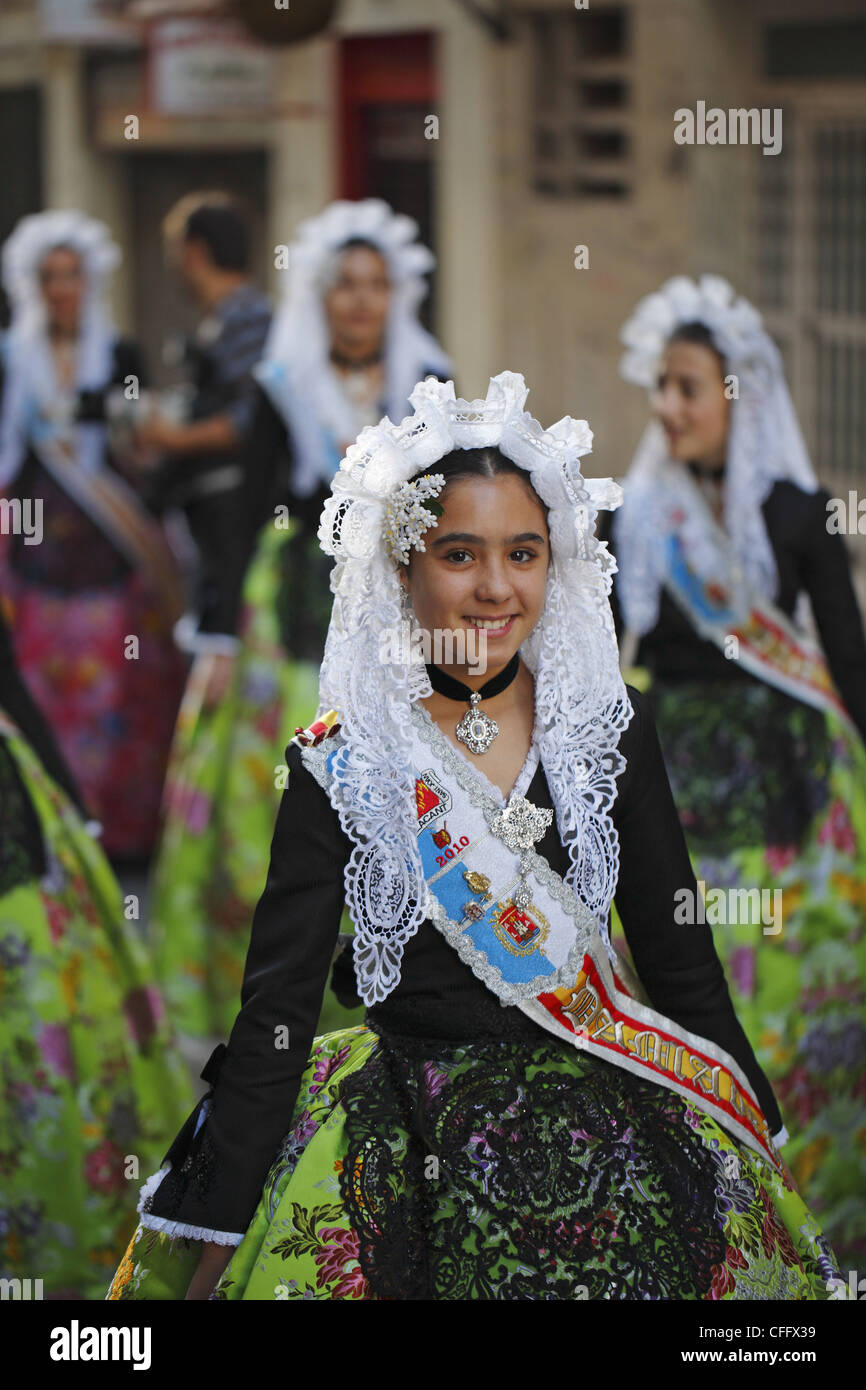 Spanish girls wearing traditional clothing during the street procession ...