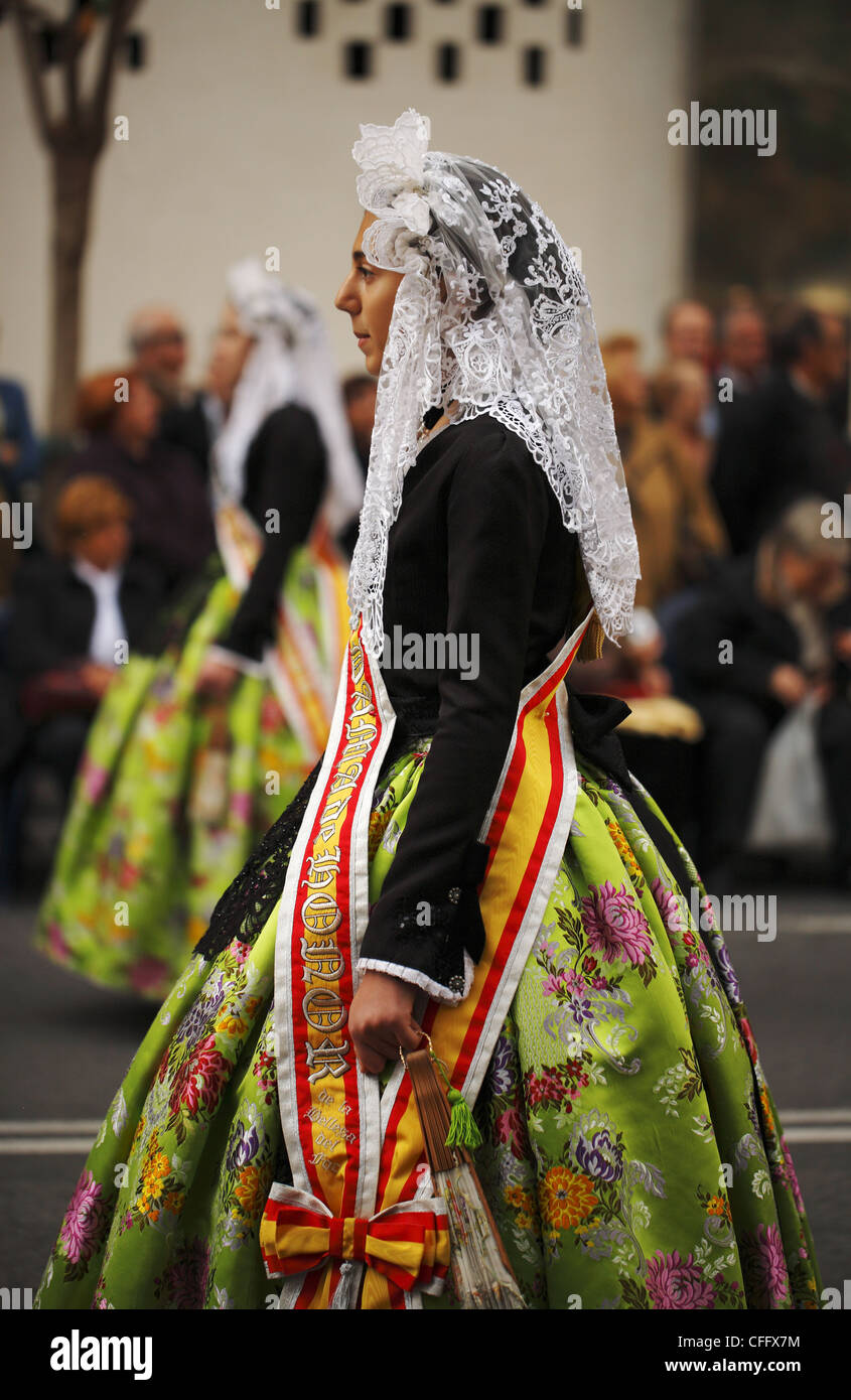 Spanish girls wearing traditional clothing during the street procession ...