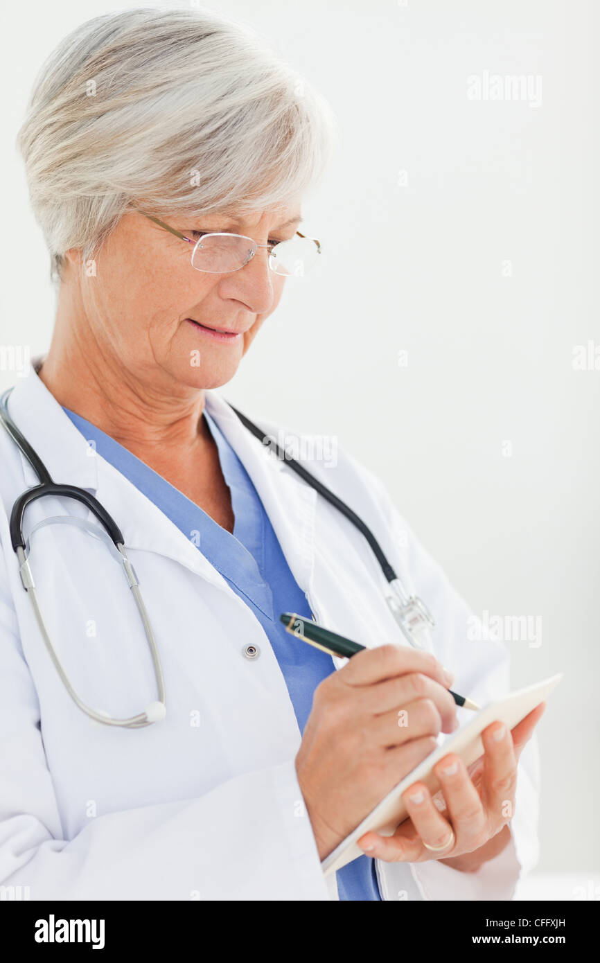Mature woman doctor filling hi-res stock photography and images - Alamy