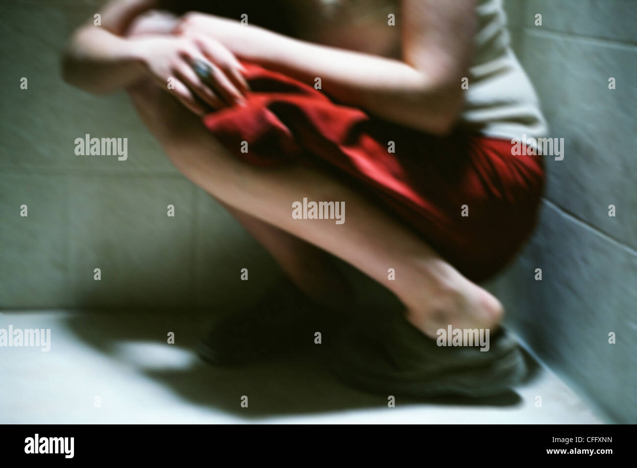 Woman in Red Skirt Crouching Stock Photo - Alamy