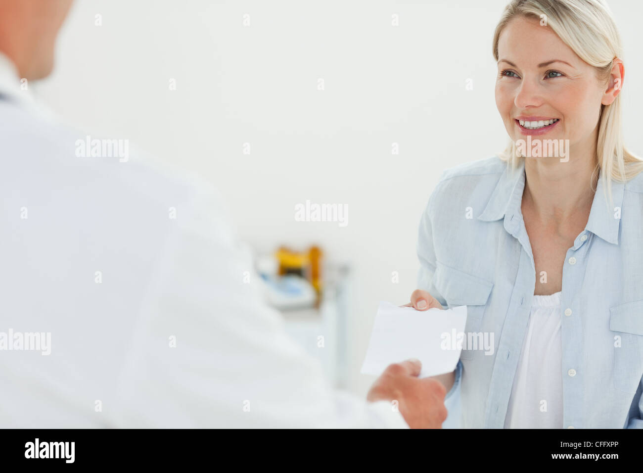 Smiling patient receiving prescription from her doctor Stock Photo - Alamy