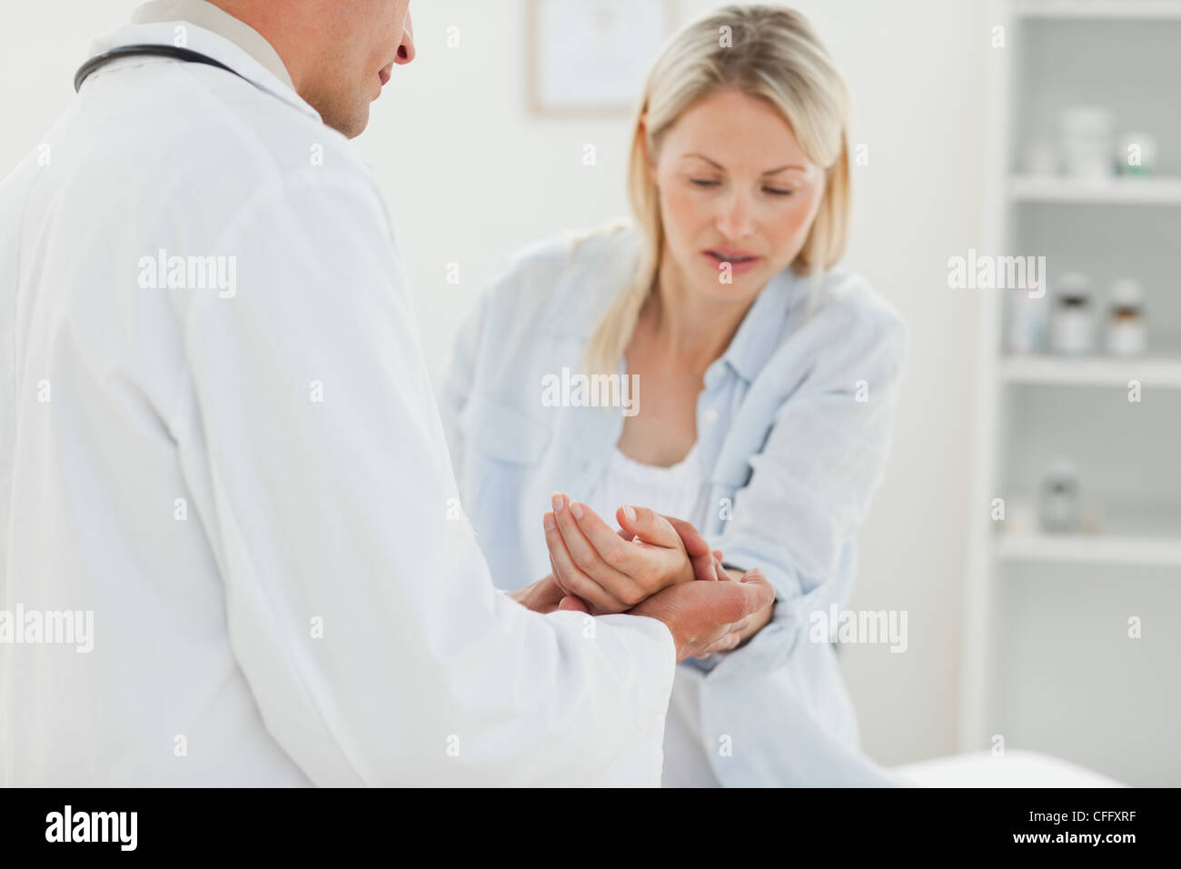 Doctor checking his patients pulse Stock Photo - Alamy