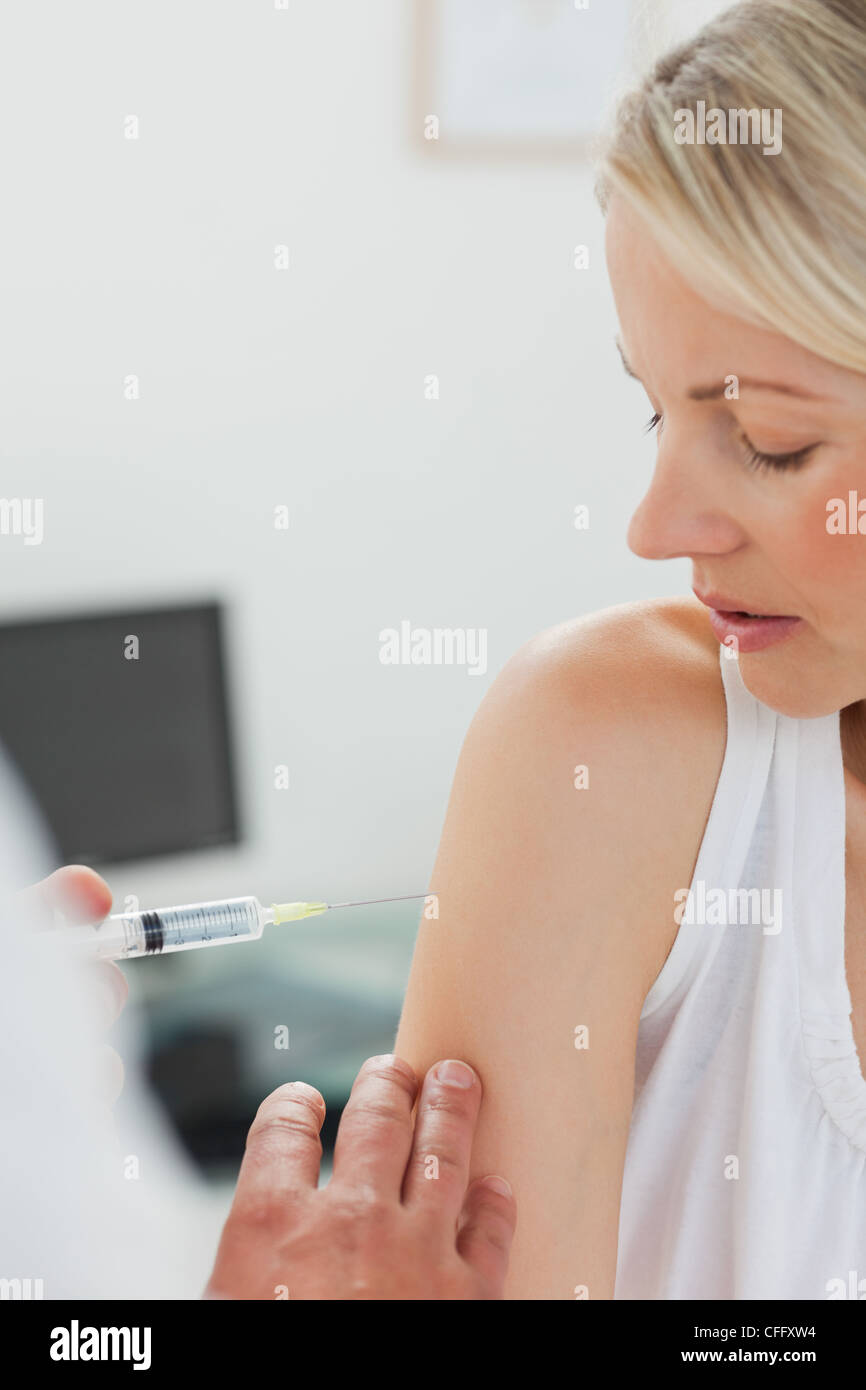 Woman getting an injection from her doctor Stock Photo - Alamy