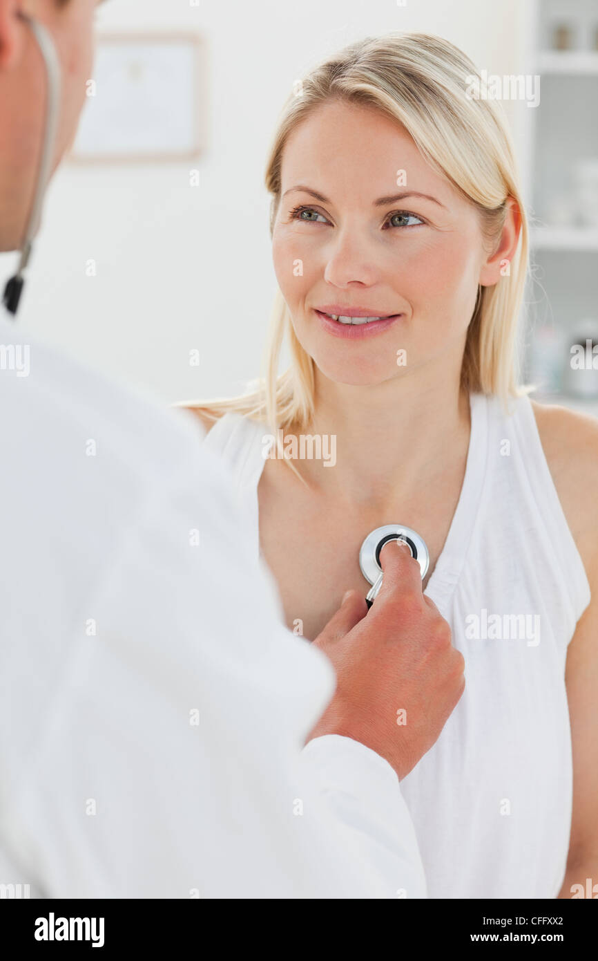Woman getting her heart beat checking by her doctor Stock Photo - Alamy