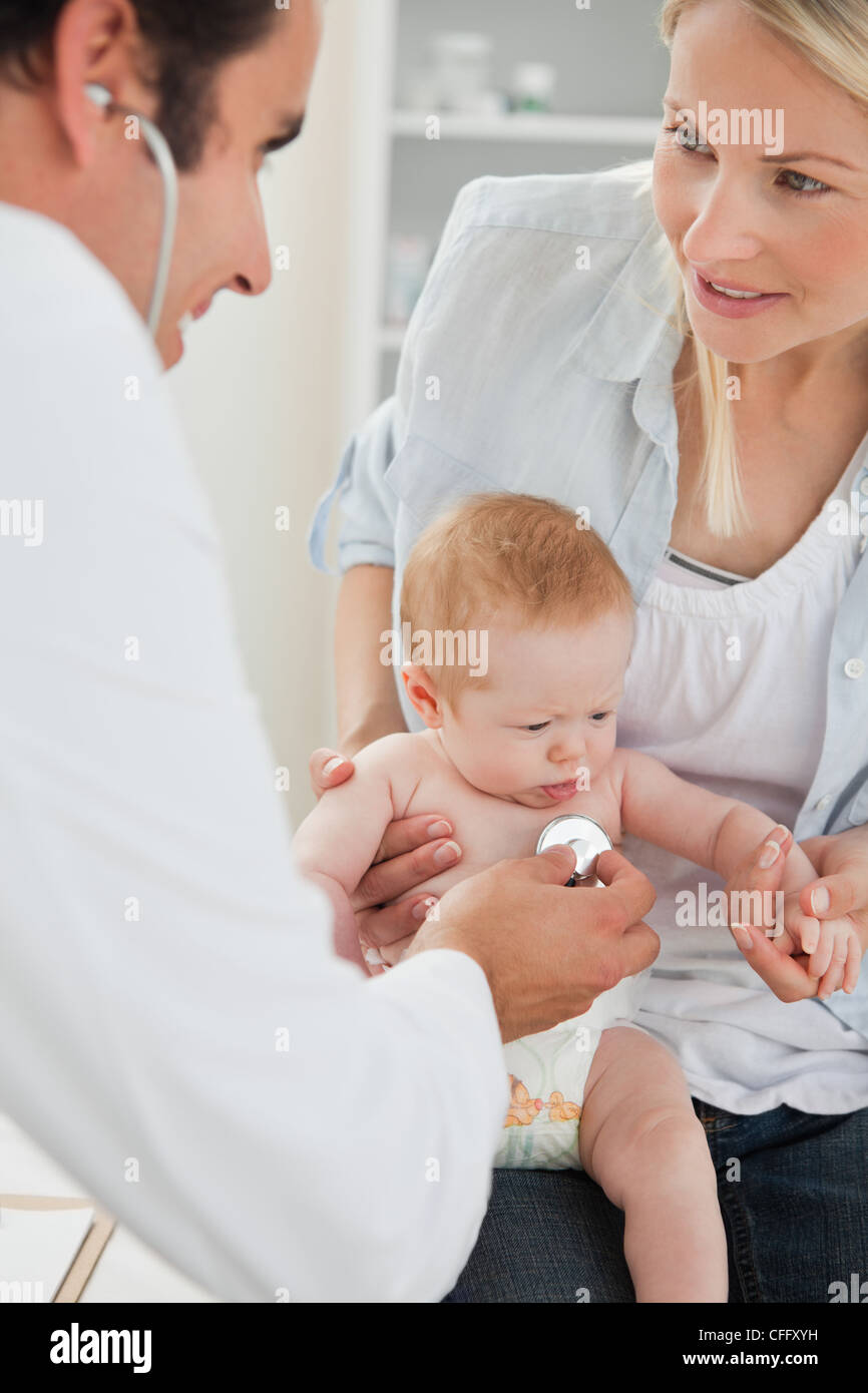 Doctor taking baby's heart beat Stock Photo - Alamy
