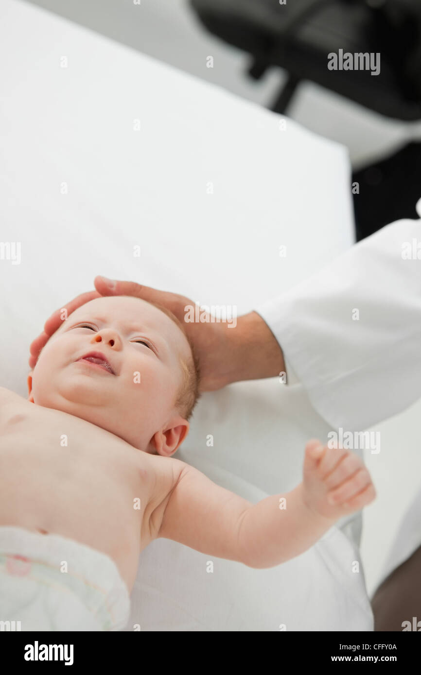Baby in doctors examination room Stock Photo - Alamy