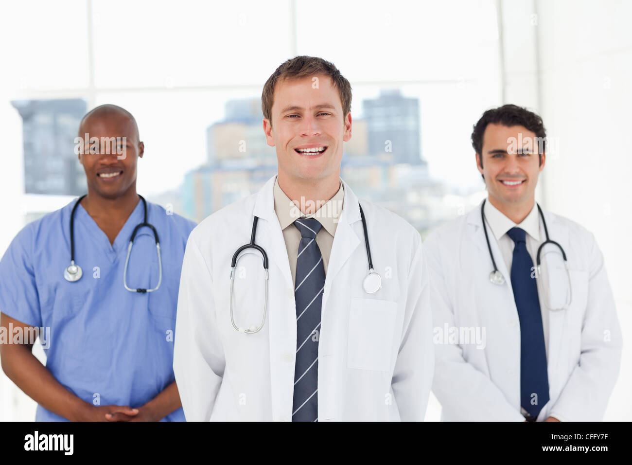 Smiling doctors standing in front of a window Stock Photo - Alamy