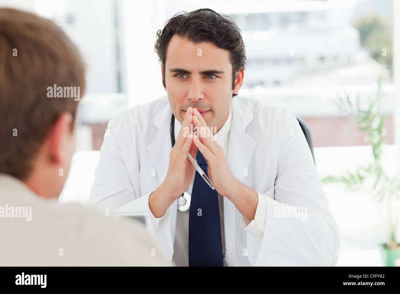 Doctor listening to his patient Stock Photo - Alamy