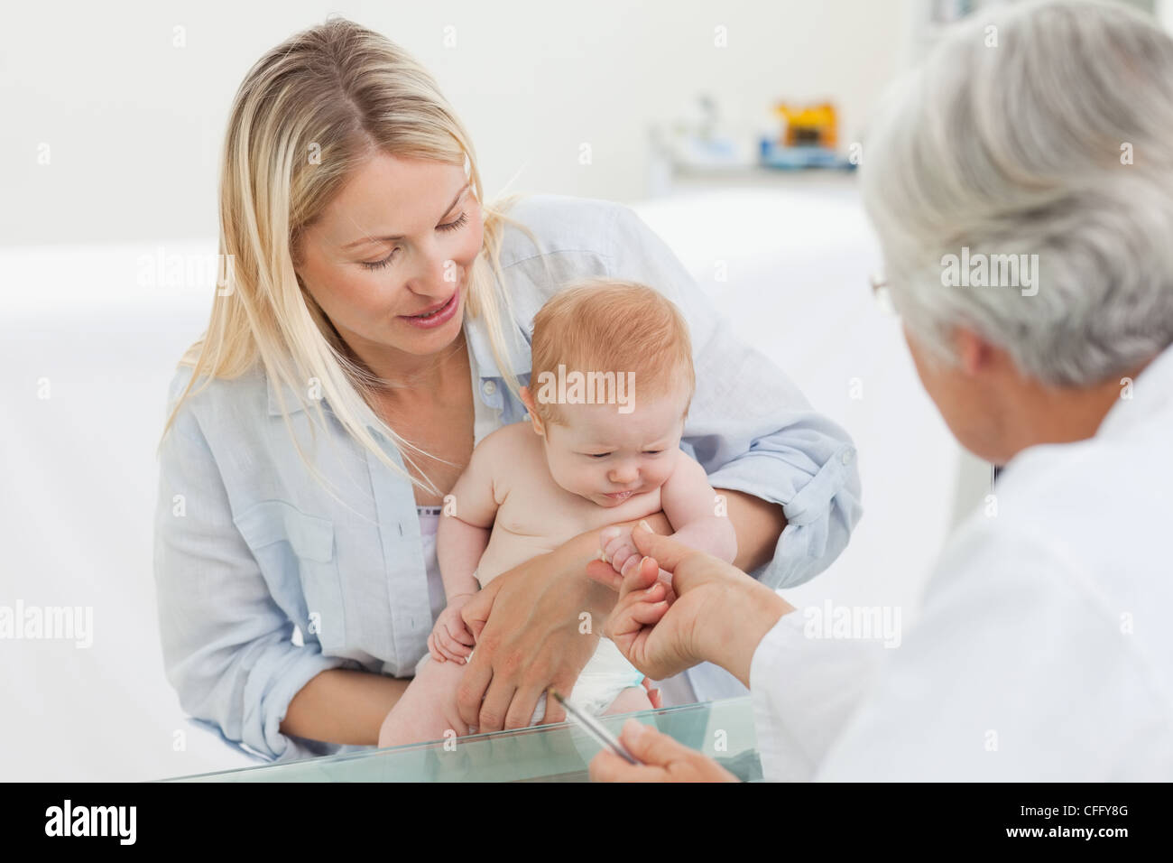 Woman baby visiting doctor hi-res stock photography and images - Alamy