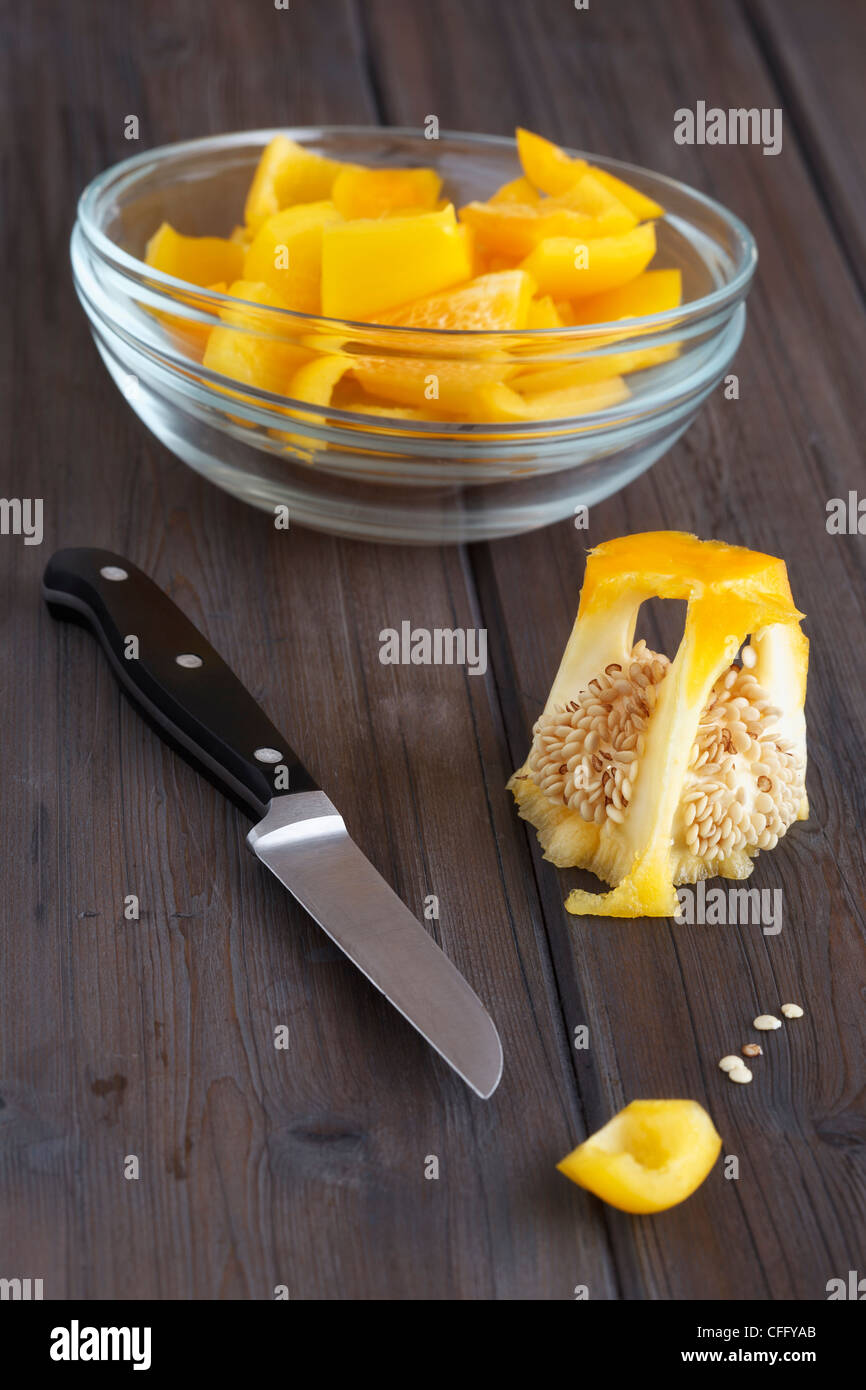 Sliced yellow pepper on a wooden board with a kitchen knife Stock Photo ...