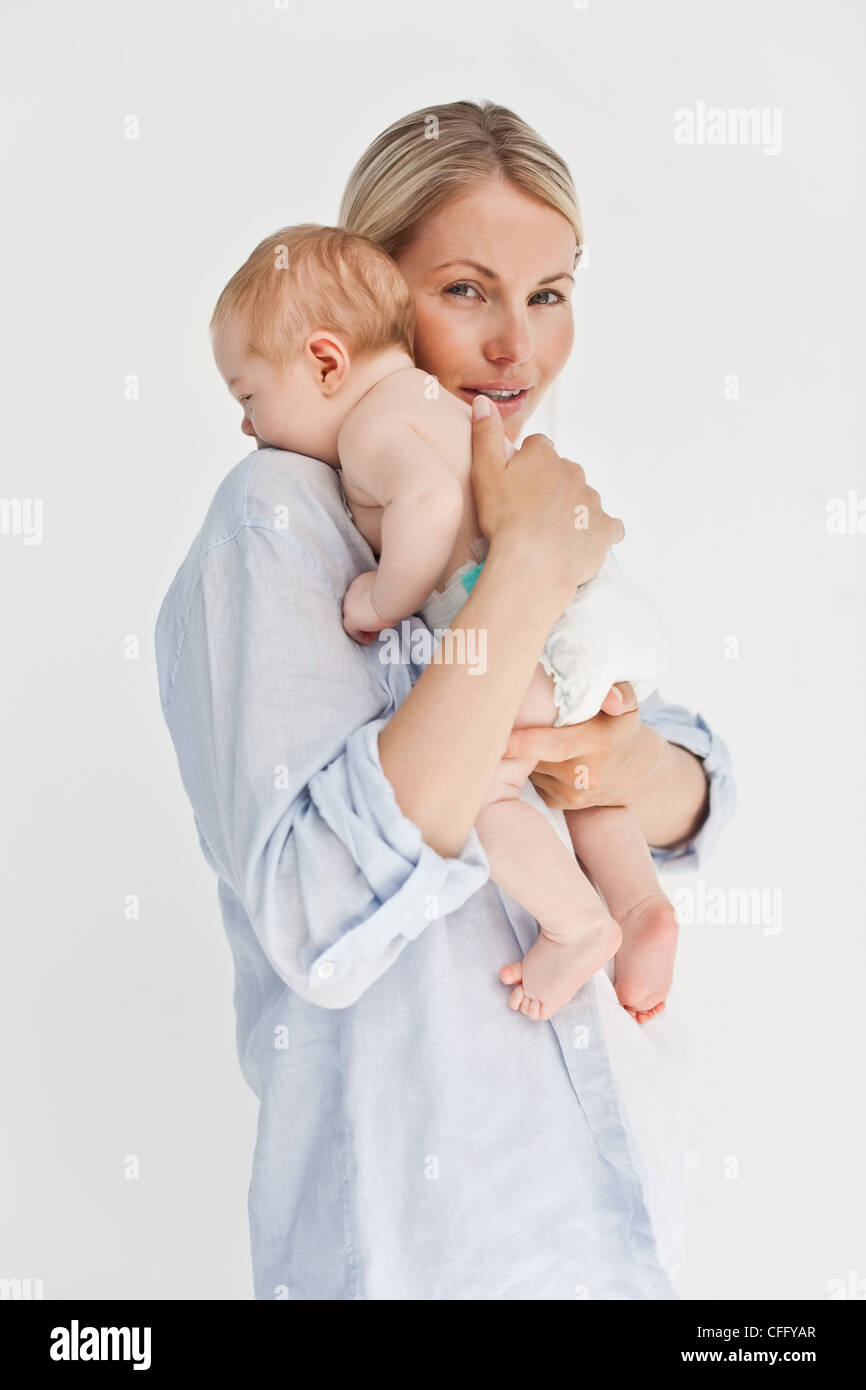 Mother hugging her baby Stock Photo - Alamy