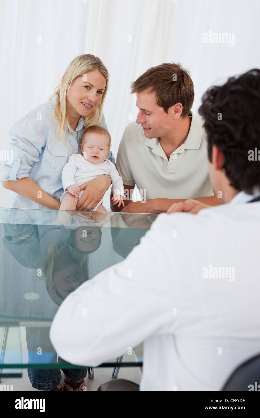 Family with their little baby seeing the doctor Stock Photo - Alamy