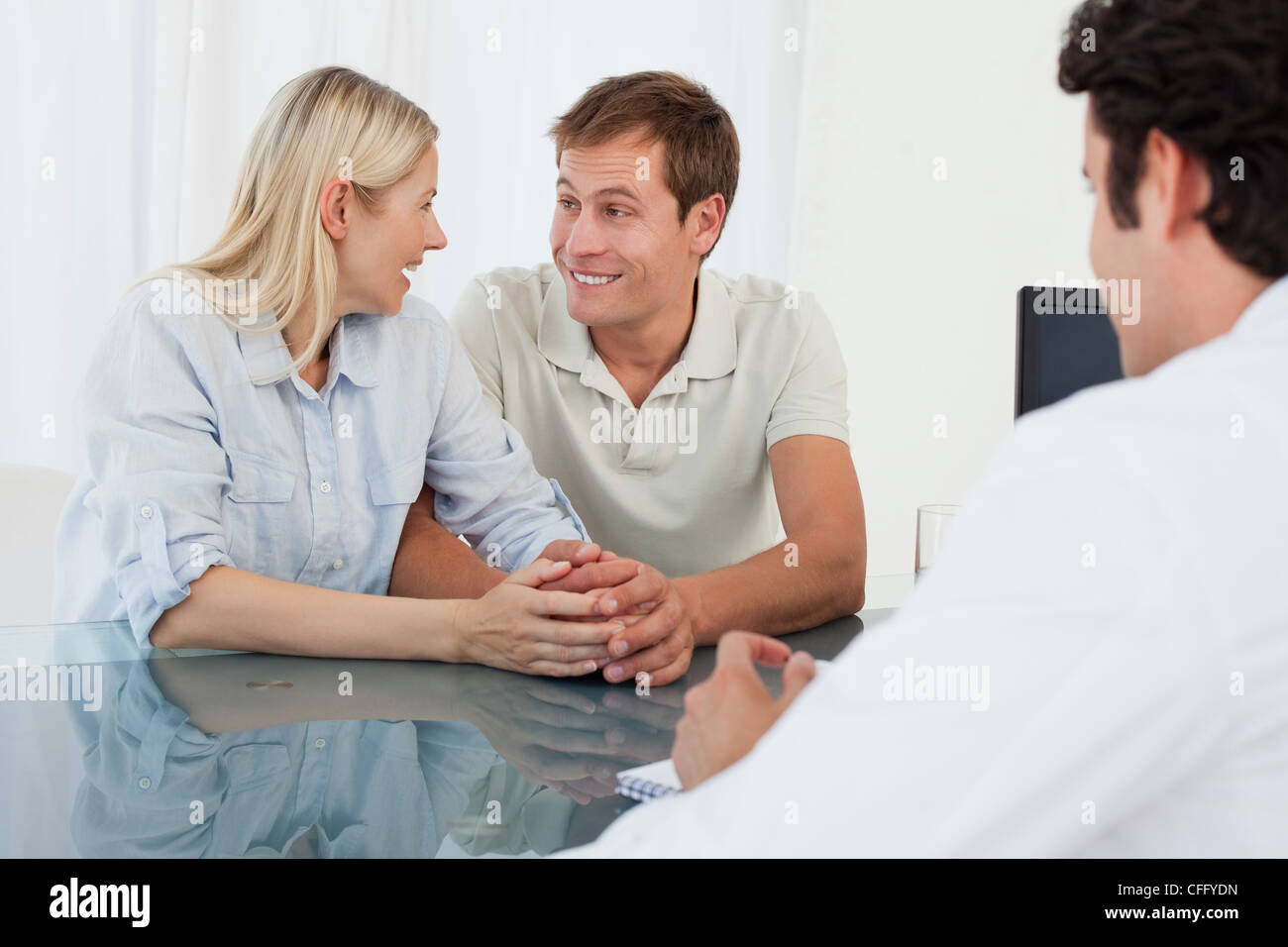 Happy couple seeing the doctor Stock Photo - Alamy