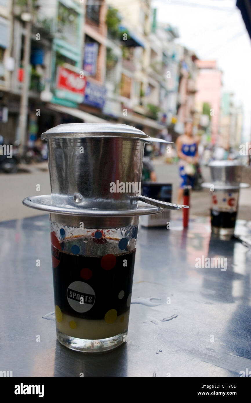 Freshly ground Vietnamese coffee is served with a uniquely engraved cup ...