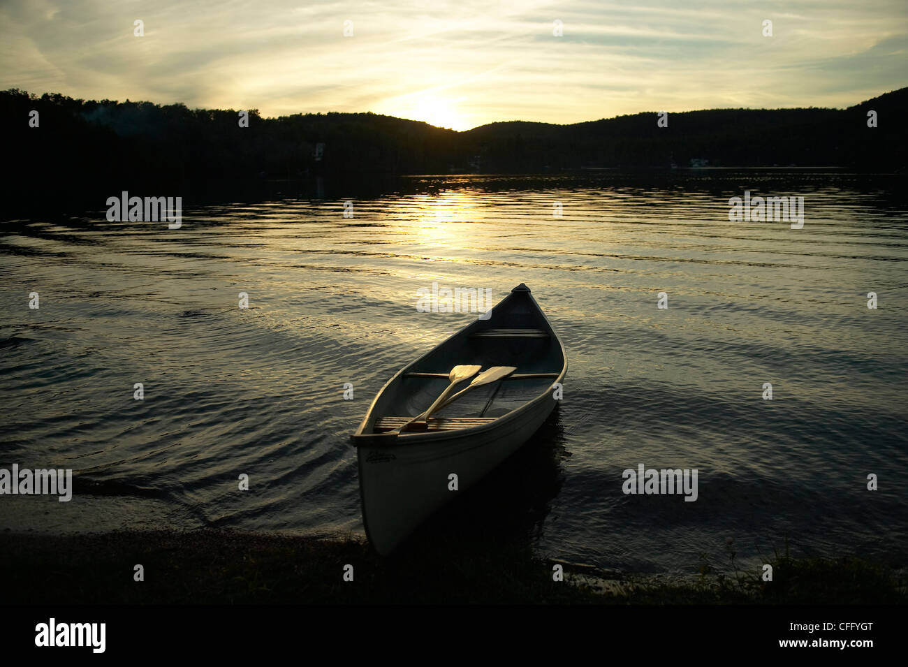 Canoe on Lake at Sunset Stock Photo - Alamy