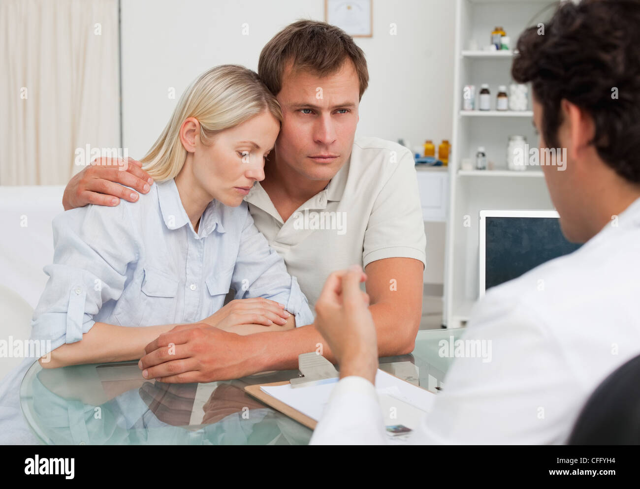 Couple getting bad news from their doctor Stock Photo - Alamy